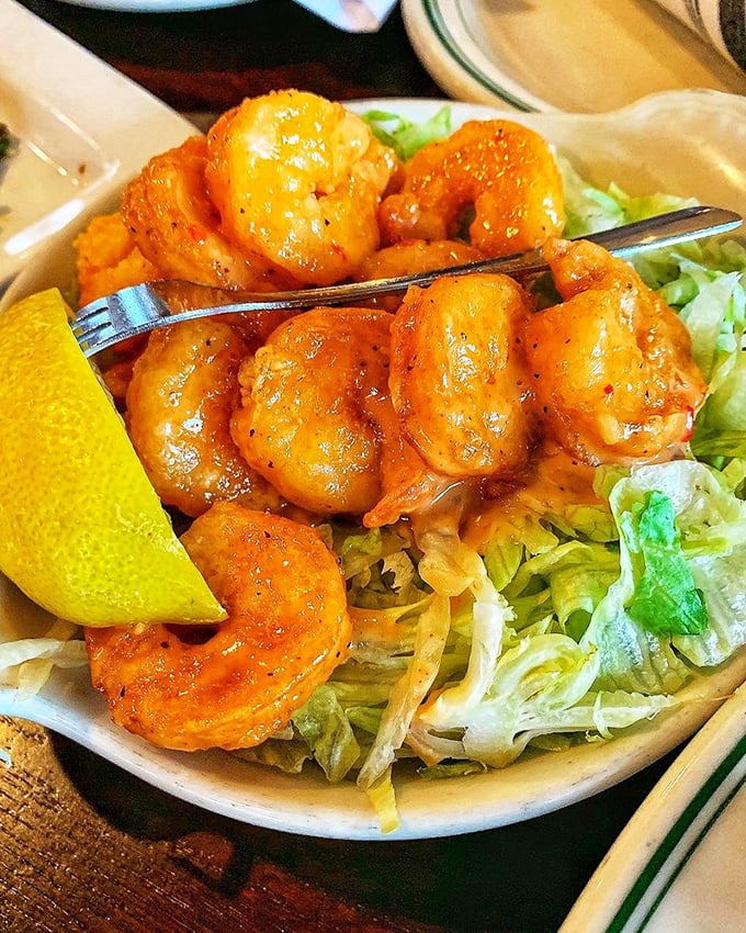 Firecracker shrimp living up to their explosive name. Spicy, succulent, and served with a lemon wedge that's not just for show.
