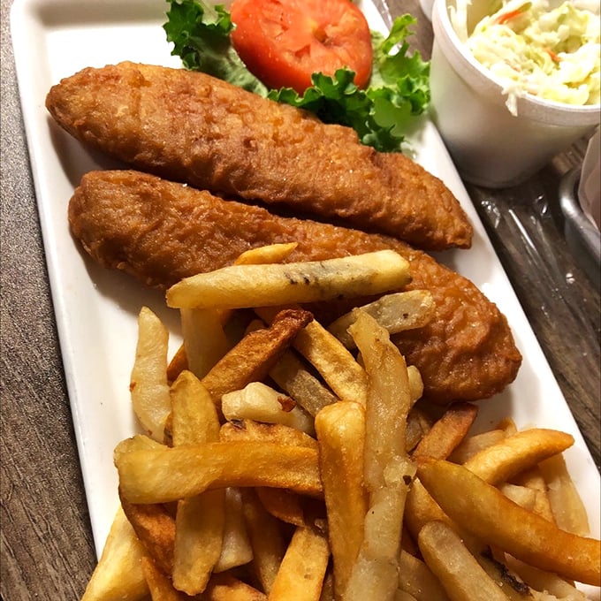 Golden-fried fish resting on a bed of fries – the kind of simple pleasure that makes you wonder why anyone bothers with fancy food.