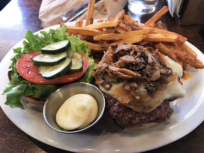Mushrooms and Swiss: a classic combination elevated to art form. Those fries aren't playing supporting role—they're co-stars.