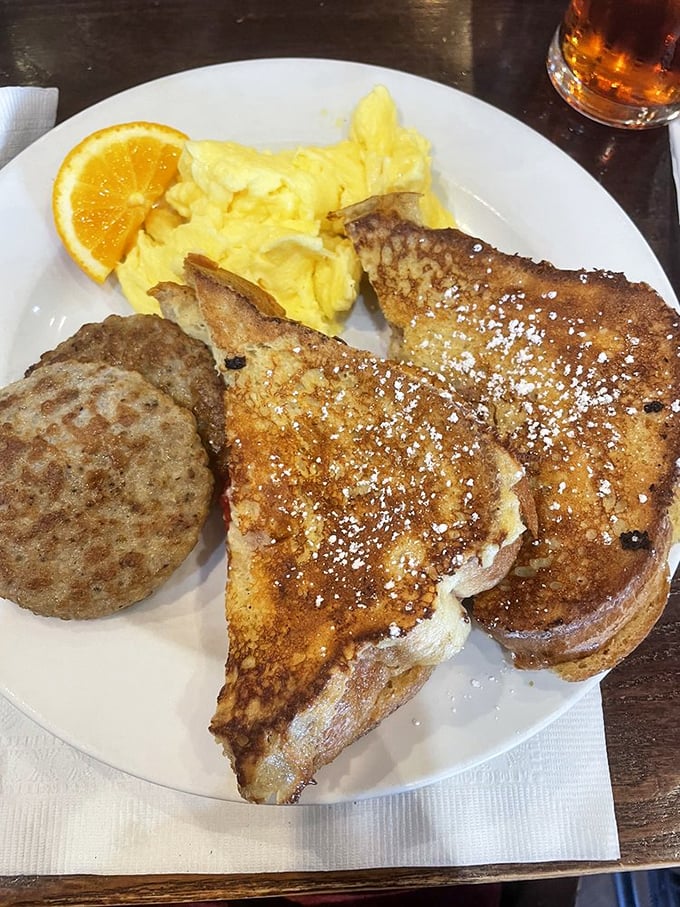 French toast that's achieved that mythical balance between crisp exterior and custardy interior, dusted with powdered sugar like the first snow of winter.