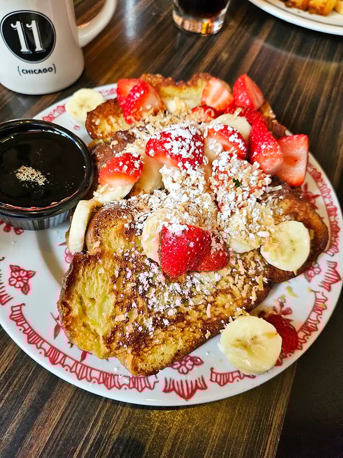 Challah French toast adorned with fresh berries and powdered sugar—breakfast that makes you question why other meals even exist.