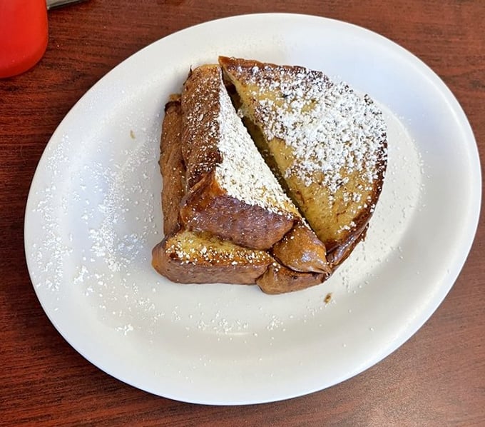 French toast that's achieved that magical caramelized exterior while maintaining a custardy center—dusted with powdered sugar like fresh Florida snow.