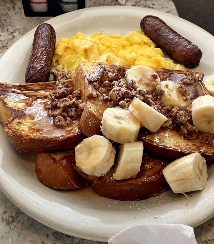 French toast that's had a serious talk with bananas, syrup, and what appears to be the breakfast fairy. Your diet plan just called—it's taking the day off.