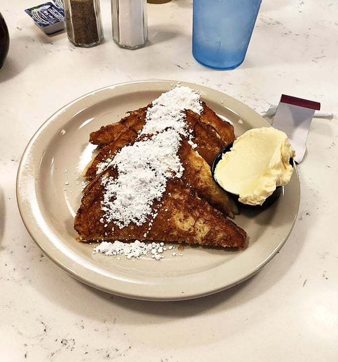 French toast that doesn't need a filter—just a generous dusting of powdered sugar and a scoop of butter melting into those perfectly caramelized ridges.