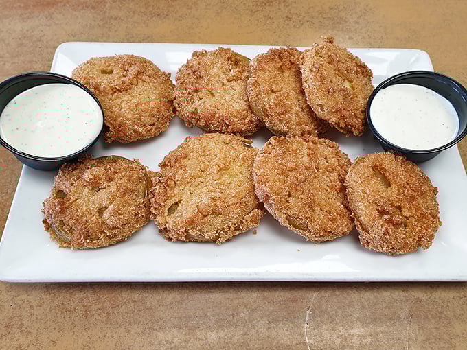 These aren't just any fried green tomatoes—they're little golden discs of Southern tradition, crispy outside and tangy inside.