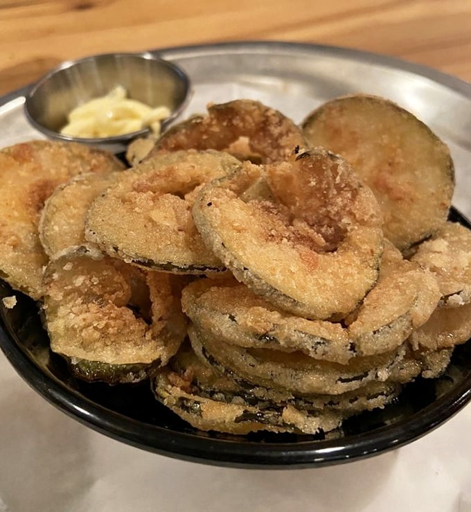 Fried pickle chips that achieve the impossible: maintaining their crunch while delivering that perfect tangy-salty punch that makes you reach for "just one more."