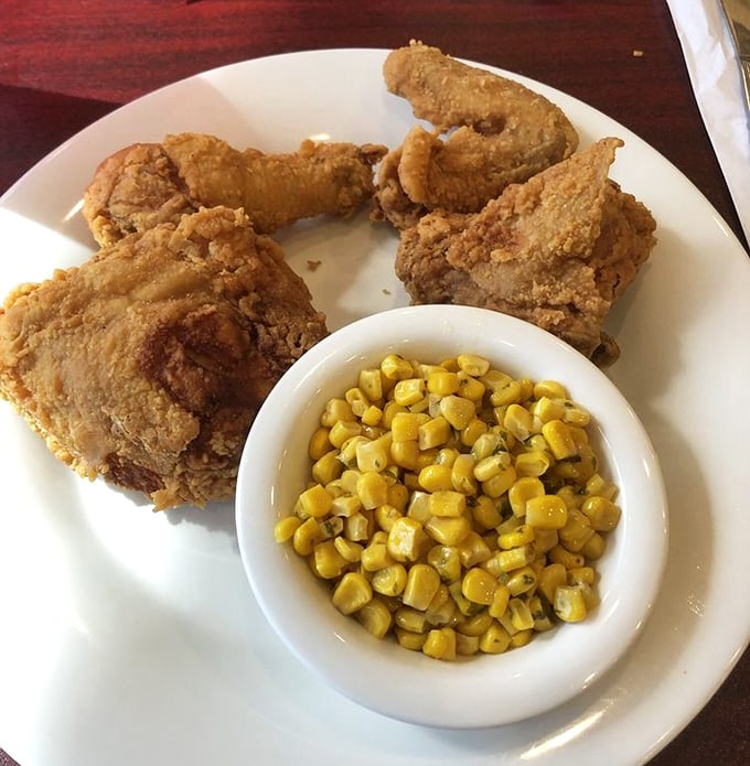 Southern fried chicken so perfectly golden, it makes the Florida sunshine jealous. That corn isn't a side dish—it's sweet moral support.
