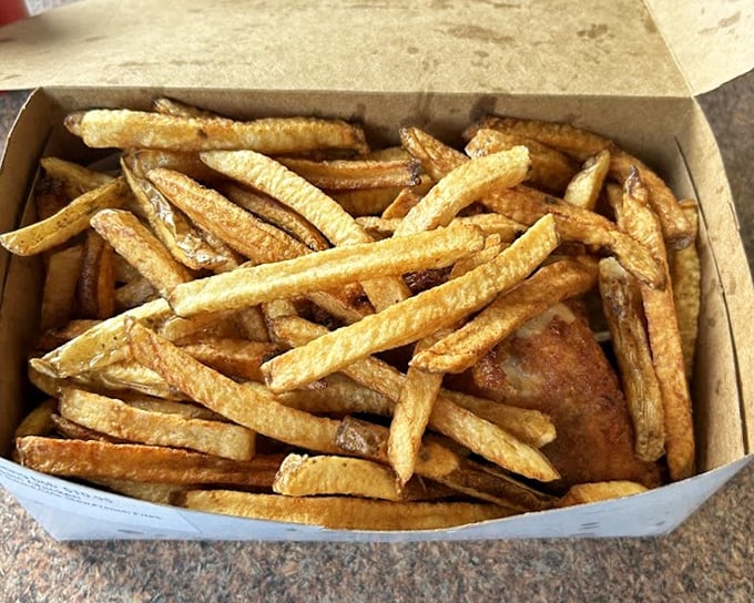 These aren't your average fast-food fries – they're golden, hand-cut treasures that deserve their own spotlight, even when sharing a plate with the famous chicken.