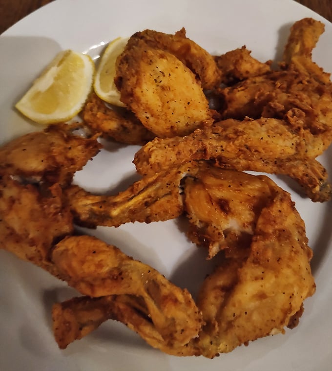 Crispy, golden-fried frog legs with a squeeze of lemon—the kind of adventurous option that separates curious eaters from the merely hungry.