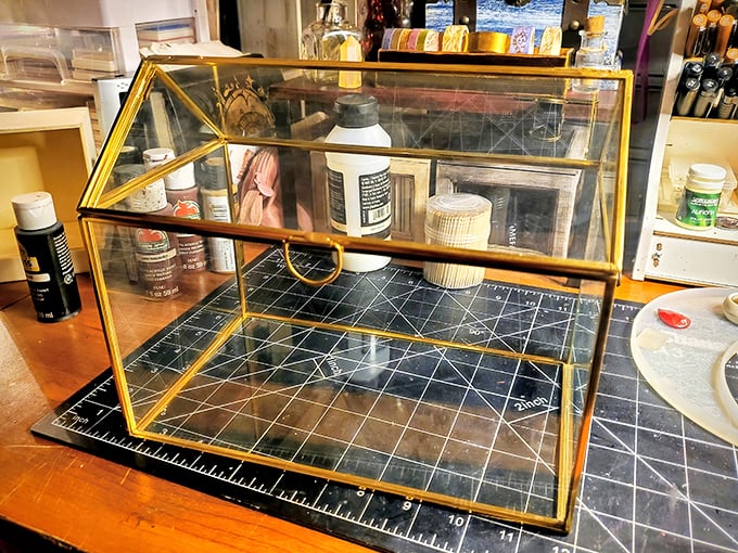 A vintage glass display case waits for its next purpose. Perhaps displaying collectibles, or becoming the world's fanciest terrarium—the possibilities are endless.