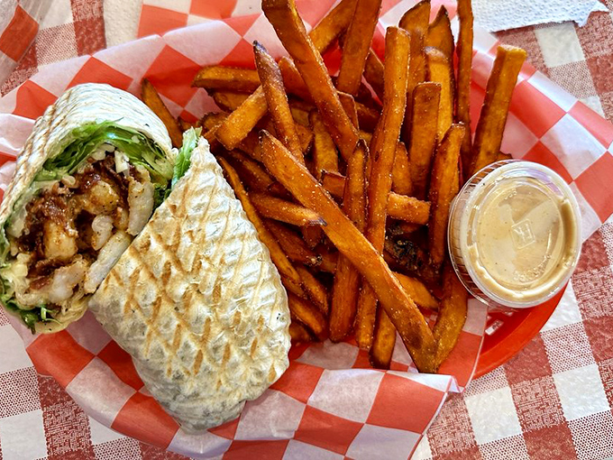 This grilled wrap isn't just lunch—it's edible architecture with layers of flavor held together in a perfectly pressed tortilla alongside crispy fries.