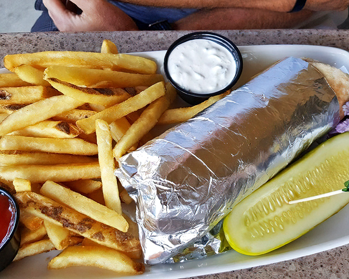 When a sandwich needs to wear a foil tuxedo, you know you're in for something special. Those fries aren't just sides—they're co-stars.