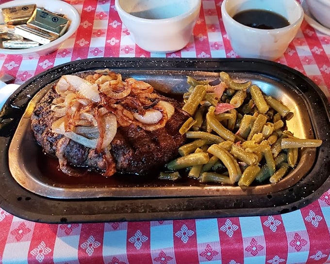 A hamburger steak topped with sautéed onions that doesn't need fancy aioli or artisanal anything—just green beans and your undivided attention.