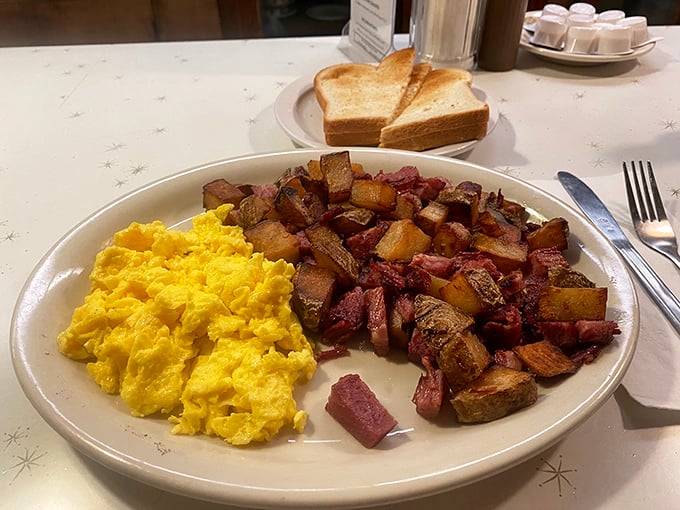 Breakfast of champions: sunshine-yellow eggs alongside corned beef hash that's been properly introduced to the griddle. The toast stands by, ready for its supporting role.