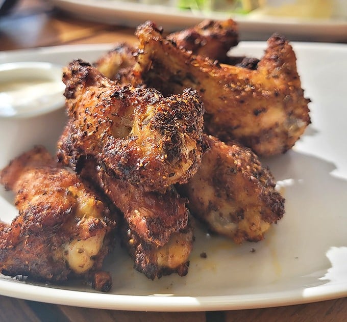 These aren't just wings—they're flavor bombs with a perfect char that would make any backyard grillmaster secretly take notes between bites.