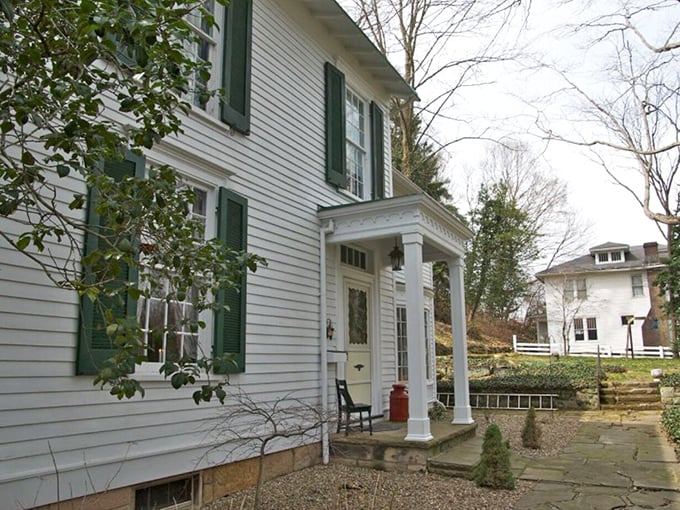 Classic white clapboard with green shutters—the architectural equivalent of comfort food. This historic home embodies the gracious hospitality that defines river town living.