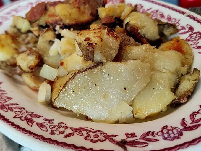 These home fries deserve their own fan club—crispy edges, tender centers, and seasoned with what can only be decades of griddle wisdom and a touch of diner magic.