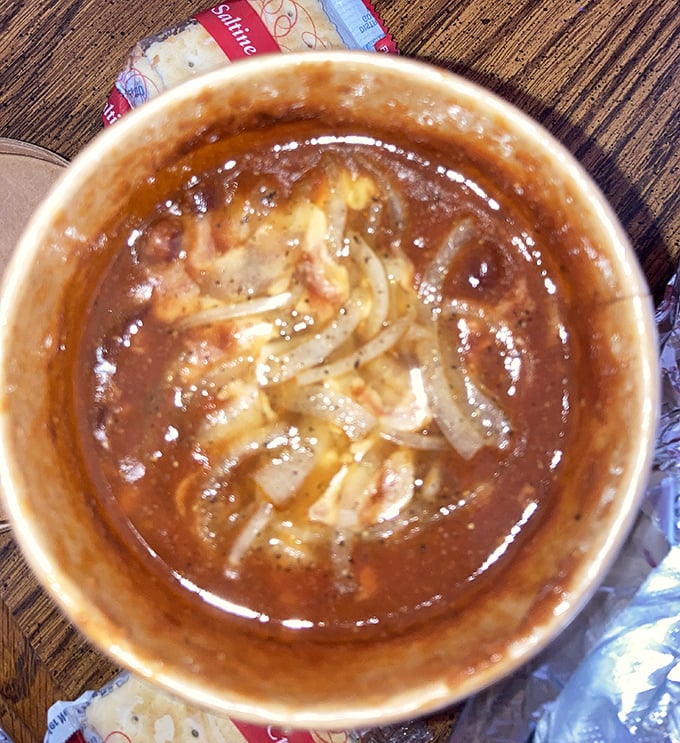 A bowl of homemade chili that would make your grandmother both jealous and proud. Those onions floating on top are like a life raft in a sea of flavor.
