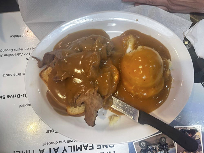 The hot beef sandwich—where gravy isn't just a condiment, it's a lifestyle choice. This plate understands that some days, you need food that hugs you back.