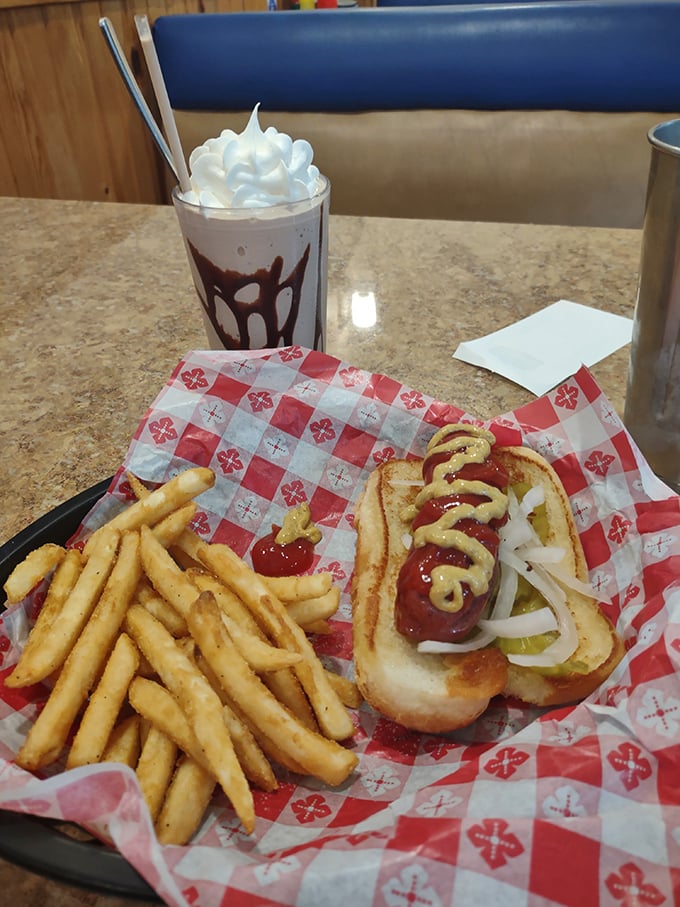 Hot dogs and fries served on classic red and white checkered paper—comfort food that speaks a universal language of deliciousness.