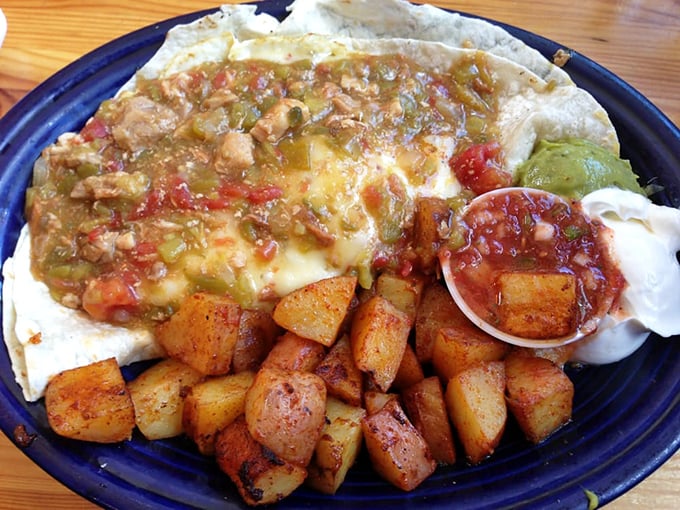 The Huevos Rancheros arrive like a colorful fiesta, where crispy potatoes and spicy green chili perform a delicious dance on your taste buds.
