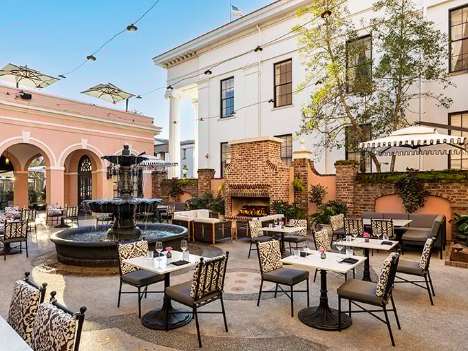 This courtyard dining space epitomizes Charleston's outdoor elegance. Even the fountain seems to whisper, "Your Instagram followers are about to be very jealous."
