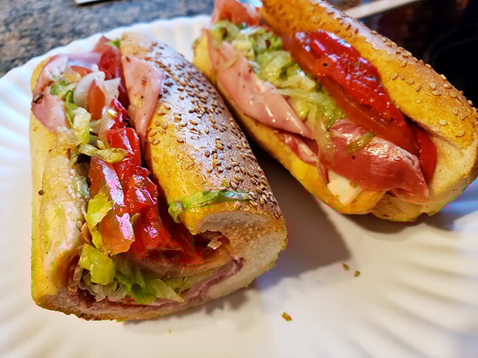This Italian hoagie showcases the architectural brilliance of proper sandwich construction—layers of meat, those roasted red peppers, and just enough oil to make your mouth water.