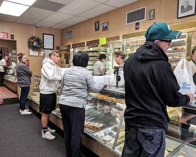 The bustling interior reveals the bakery's no-nonsense approach—that "AUTHORIZED PERSONNEL ONLY" sign is protecting some serious baking magic.