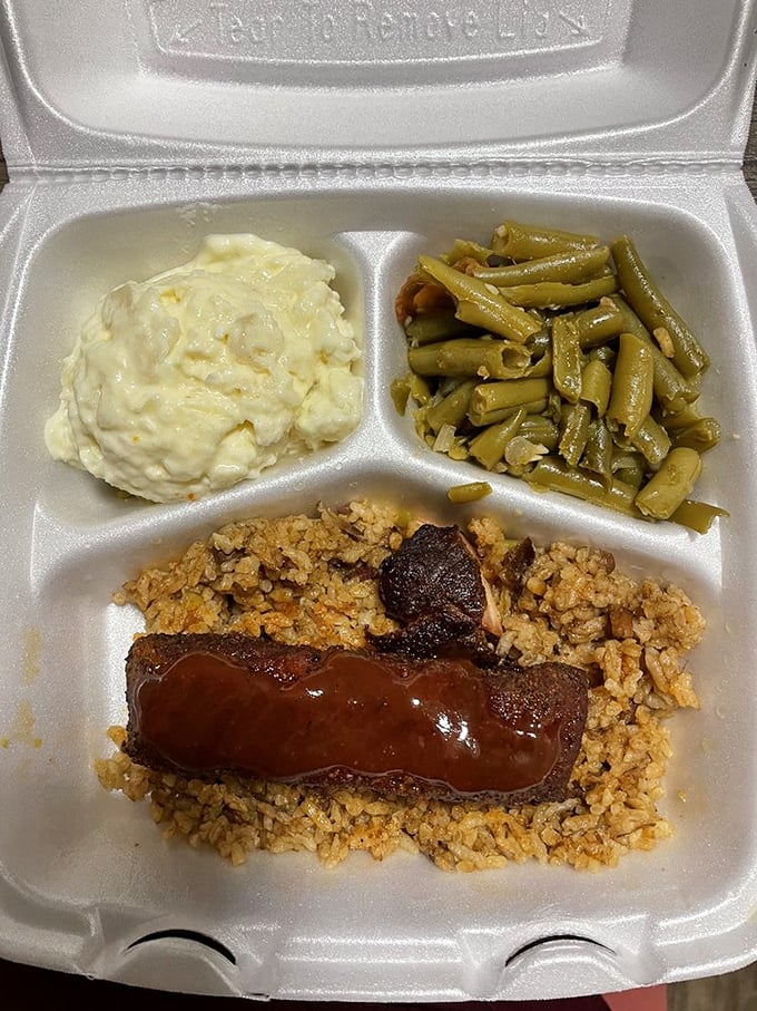 Jambalaya with sticky rice, tender meat, and soul-warming sides arranged in a to-go container that's almost too pretty to open.