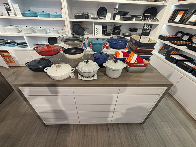 Le Creuset's colorful cookware display tempts home chefs with Dutch ovens that cost less than the dinner party you'll host with them.