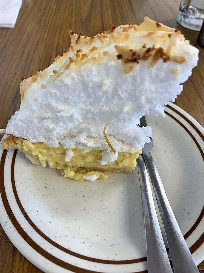 This slice of lemon meringue pie isn't just dessert—it's a fluffy, sweet cloud resting on sunshine. The kind of pie your grandmother would approve of.