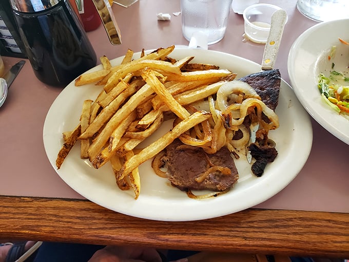 Liver and onions – the dish that separates casual diners from true comfort food aficionados – served with perfect golden onions.