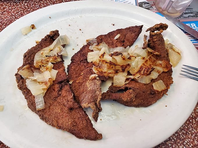 Liver and onions—that divisive diner classic that separates the culinary adventurers from the cautious—served with a side of nostalgia and caramelized sweetness.