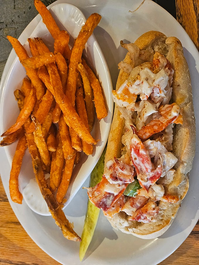 The lobster roll—a buttery vessel overflowing with sweet meat—proves that sometimes the simplest presentations create the most profound pleasures.