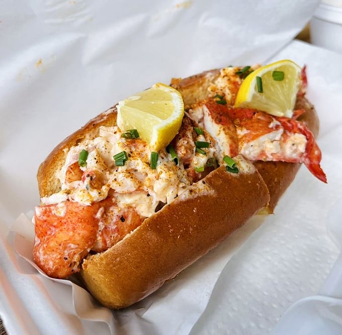 The lobster roll – a buttery, toasted vessel carrying sweet lobster meat to your mouth. Those lemon wedges aren't just for show, folks.