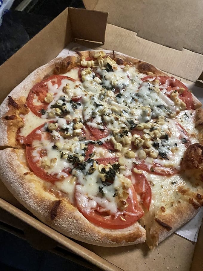 Fresh tomatoes on a perfect crust—sometimes the simplest combination speaks the most profound culinary truth.