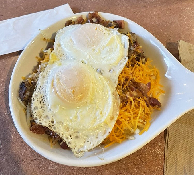 Two sunny-side up eggs crowning a mountain of breakfast potential. This skillet doesn't just feed you—it fuels adventures across Missouri's highways and byways.