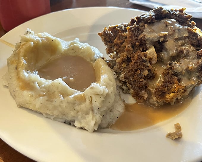 Dave's Meatloaf with a crater of mashed potatoes—comfort food geography at its finest. That gravy lake would make any stress instantly evaporate.