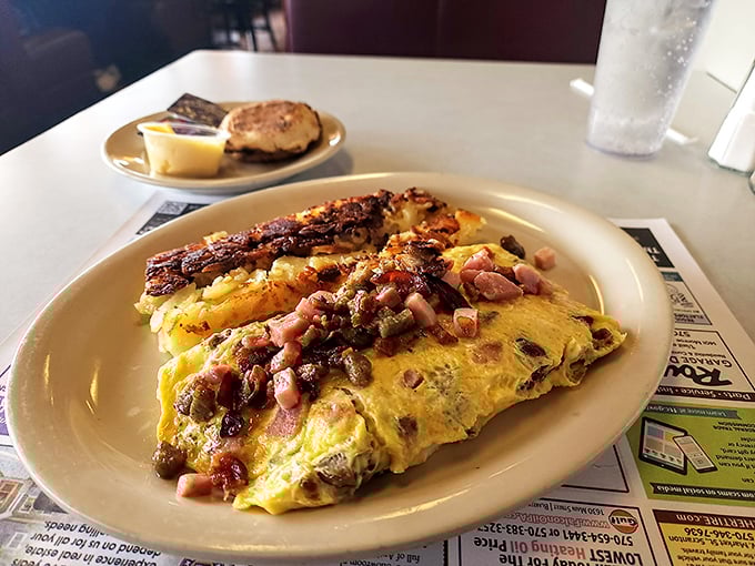 This isn't just an omelet – it's a protein festival with VIP tickets for ham and cheese, served with a side of cardiac concern and pure joy.