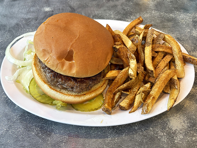The burger that launched a thousand road trips. Hand-formed Nebraska beef, properly seared, with fries that achieve that mythical balance between crispy and tender.