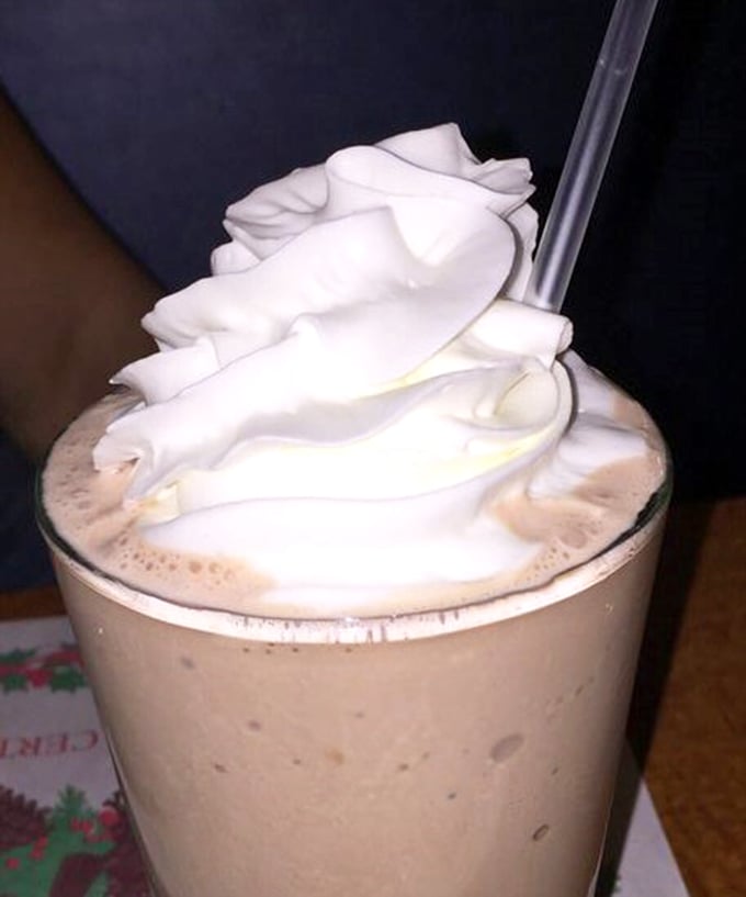 Frothy milkshake topped with a cloud of whipped cream—the kind that makes you wonder why anyone bothers with fancy desserts when classics exist.