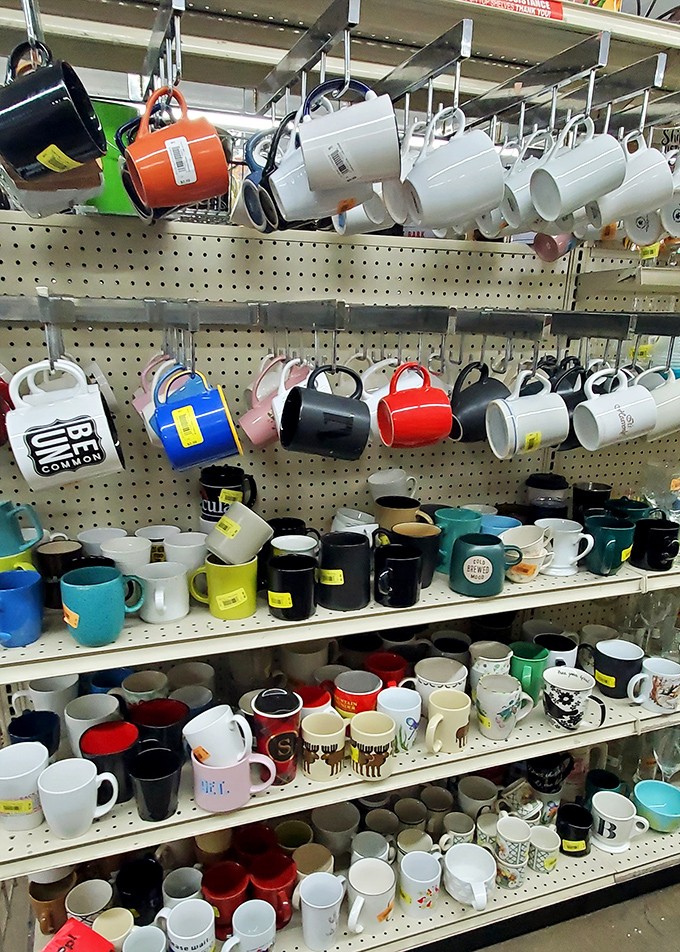The mug wall – where coffee vessels of personalities past await their chance to hold your morning brew.