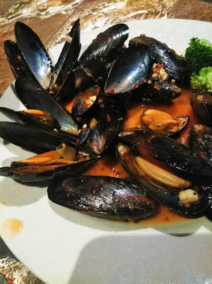 Mussels bathing in a fragrant broth that begs to be sopped up with bread. Neptune himself would approve of this oceanic treasure.