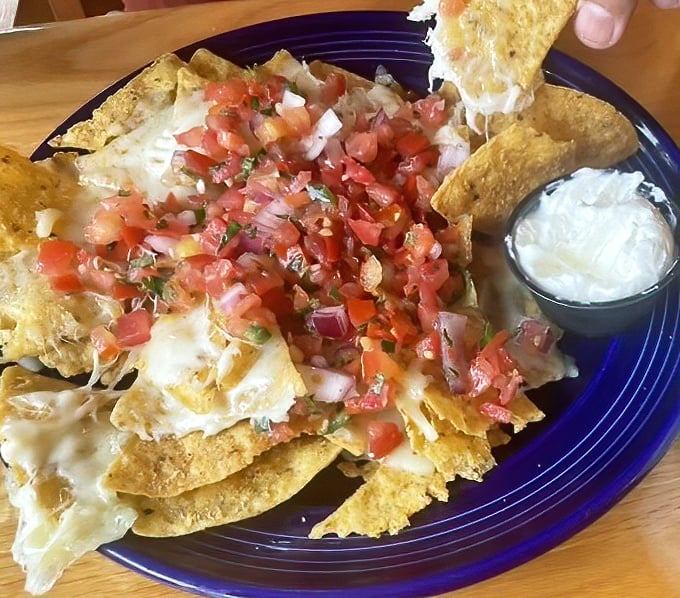 These nachos aren't messing around—they're serious business with fresh pico de gallo that brings a garden-fresh brightness to each crunchy bite.