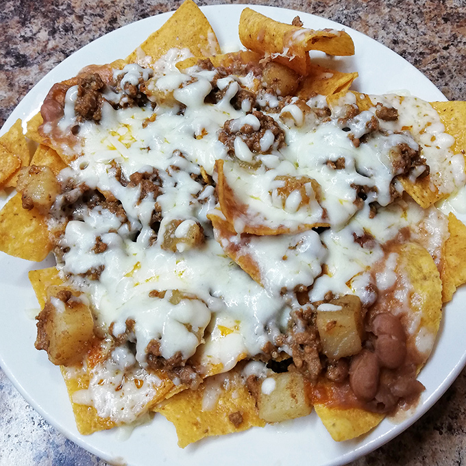 Nachos that laugh in the face of stadium versions – these loaded beauties ensure every chip gets its fair share of the melty, meaty goodness.