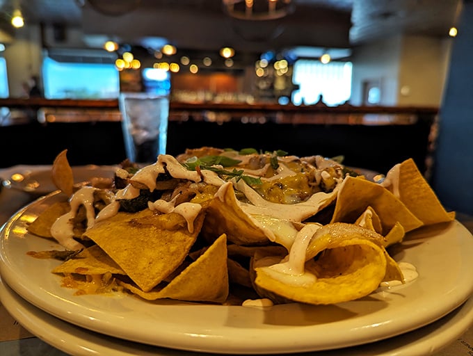 Nachos reimagined—crispy tortilla chips piled high with toppings that transform a bar snack into a legitimate dinner option.