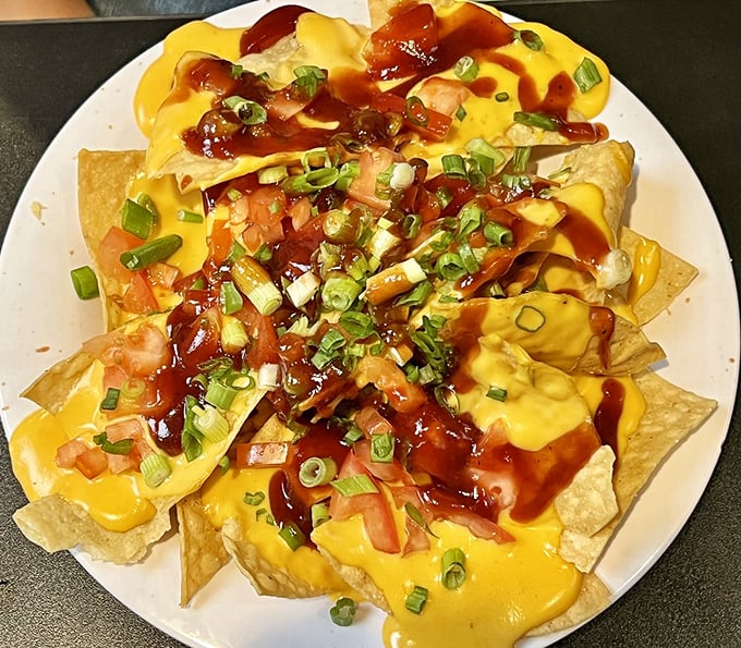 Nachos that laugh in the face of minimalism. That cheese sauce cascade is the Niagara Falls of comfort food.