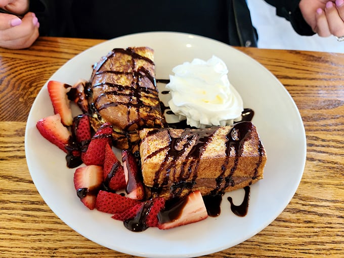 Nutella French toast drizzled with chocolate and surrounded by fresh strawberries—dessert masquerading as breakfast, and we're not complaining.