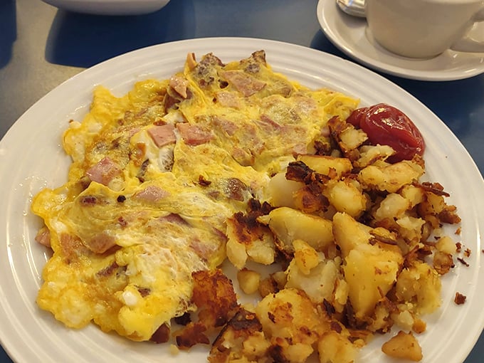 This ham and cheese omelet doesn't just satisfy hunger—it creates memories. The potatoes are merely the supporting cast in this breakfast drama.