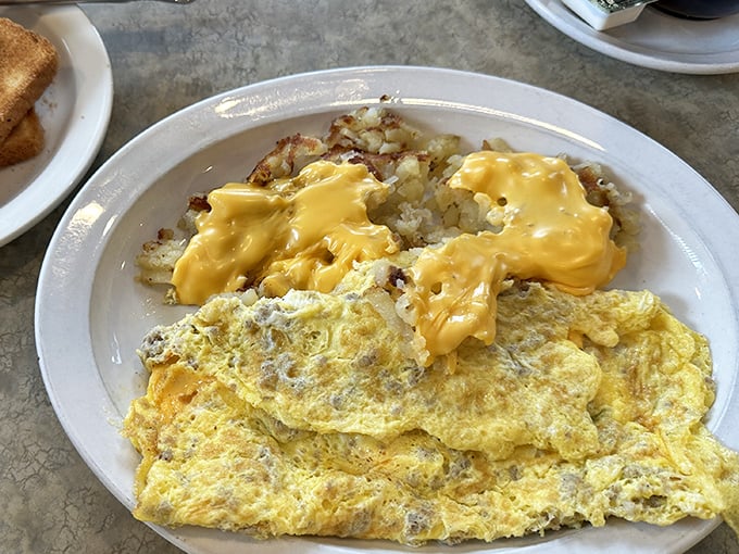 This omelet and cheese-draped hash browns combo is the breakfast equivalent of a warm hug from your favorite aunt—familiar, comforting, and exactly what you need.
